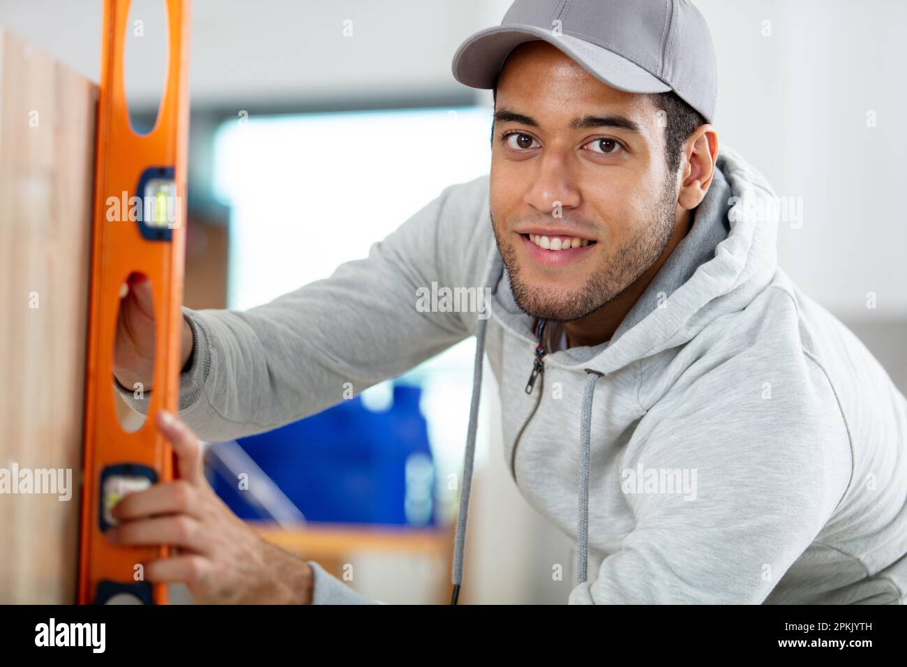 engineer checking wall with spirit level for level Stock Photo - Alamy