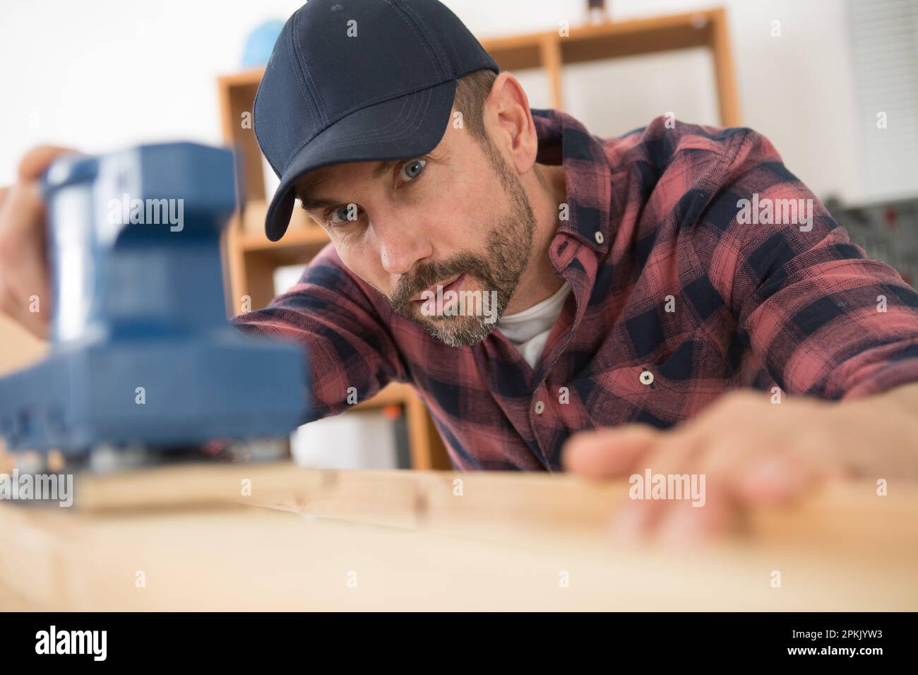 man using an electric sander Stock Photo - Alamy