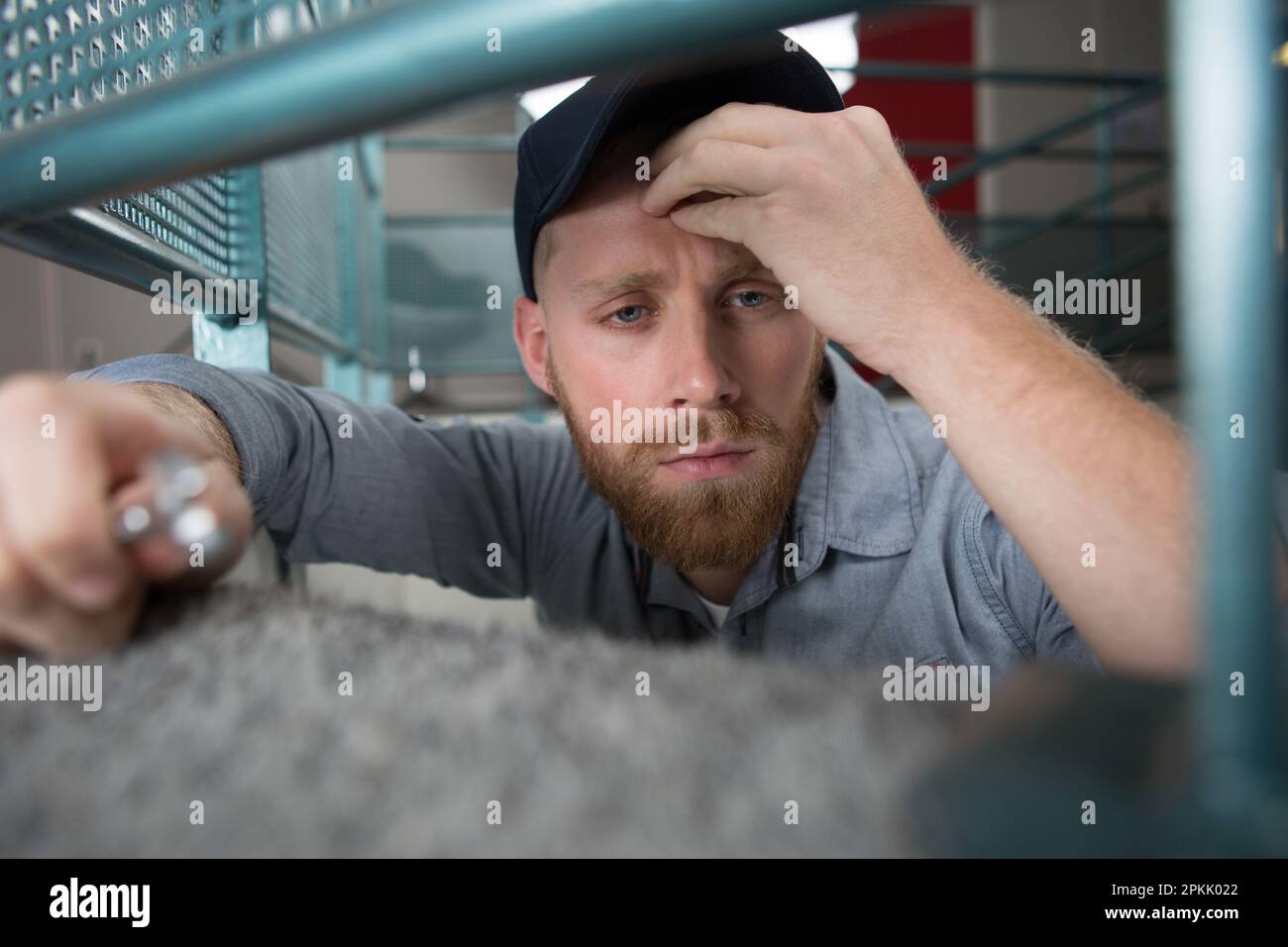 puzzled handyman planning renovation works Stock Photo - Alamy