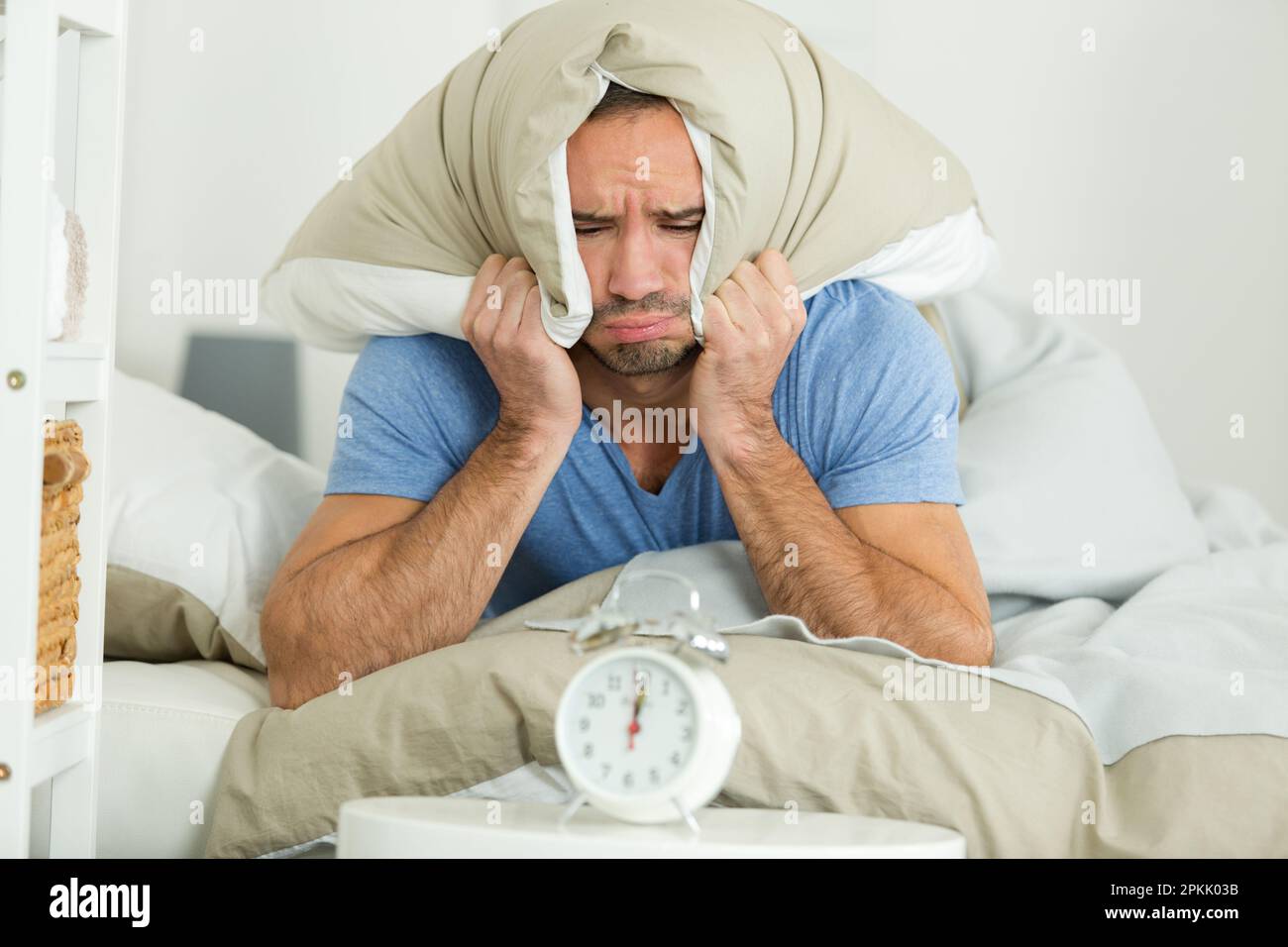 sad and upset man waking up in the morning light Stock Photo - Alamy