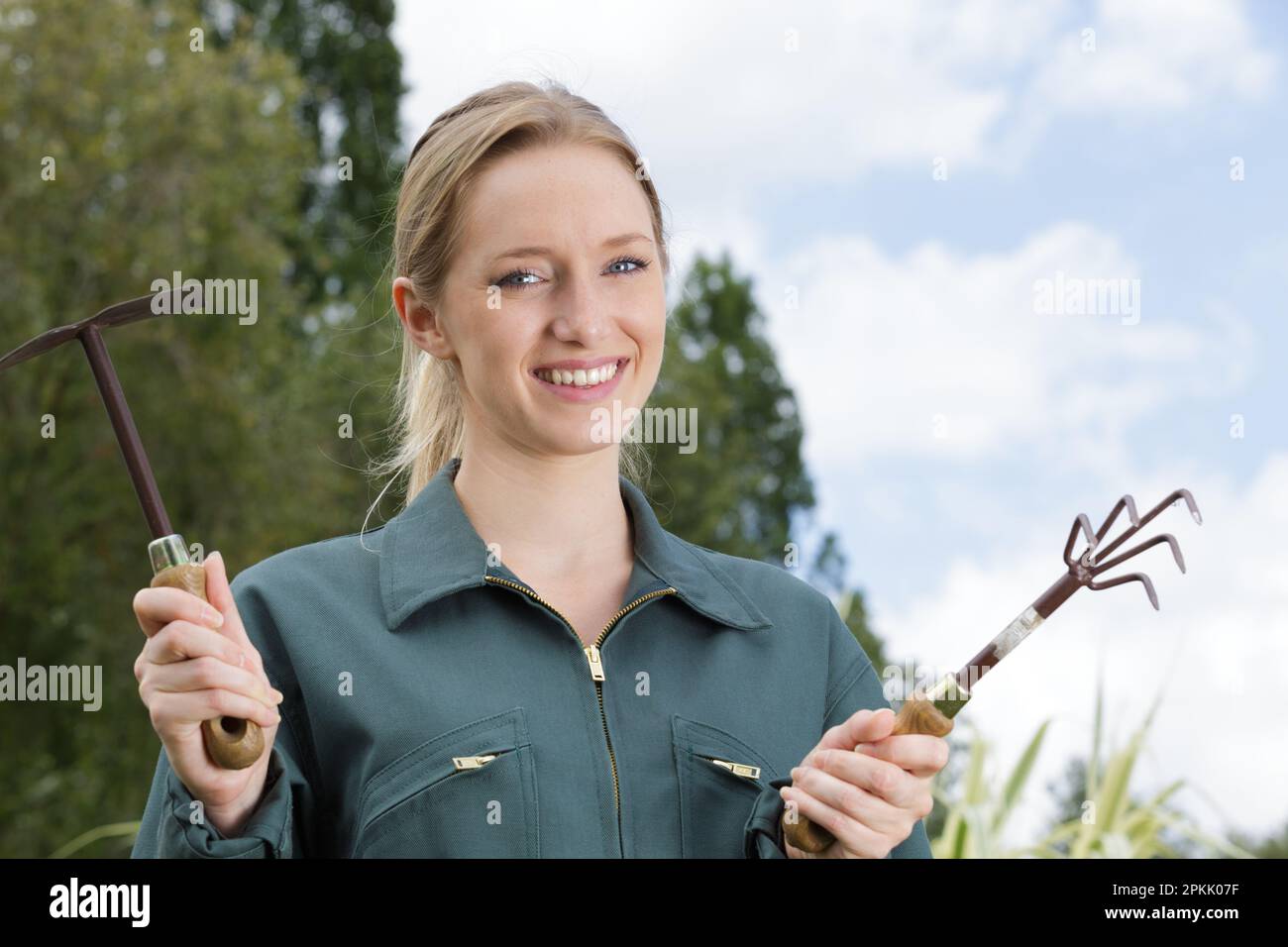 female gardener holding gardening tools Stock Photo - Alamy