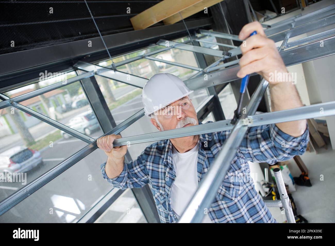 contractor erecting framework for suspended ceiling Stock Photo - Alamy