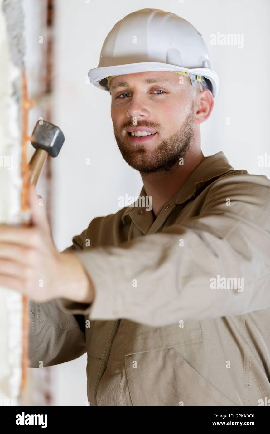 Construction worker holding sledgehammer hi-res stock photography and ...