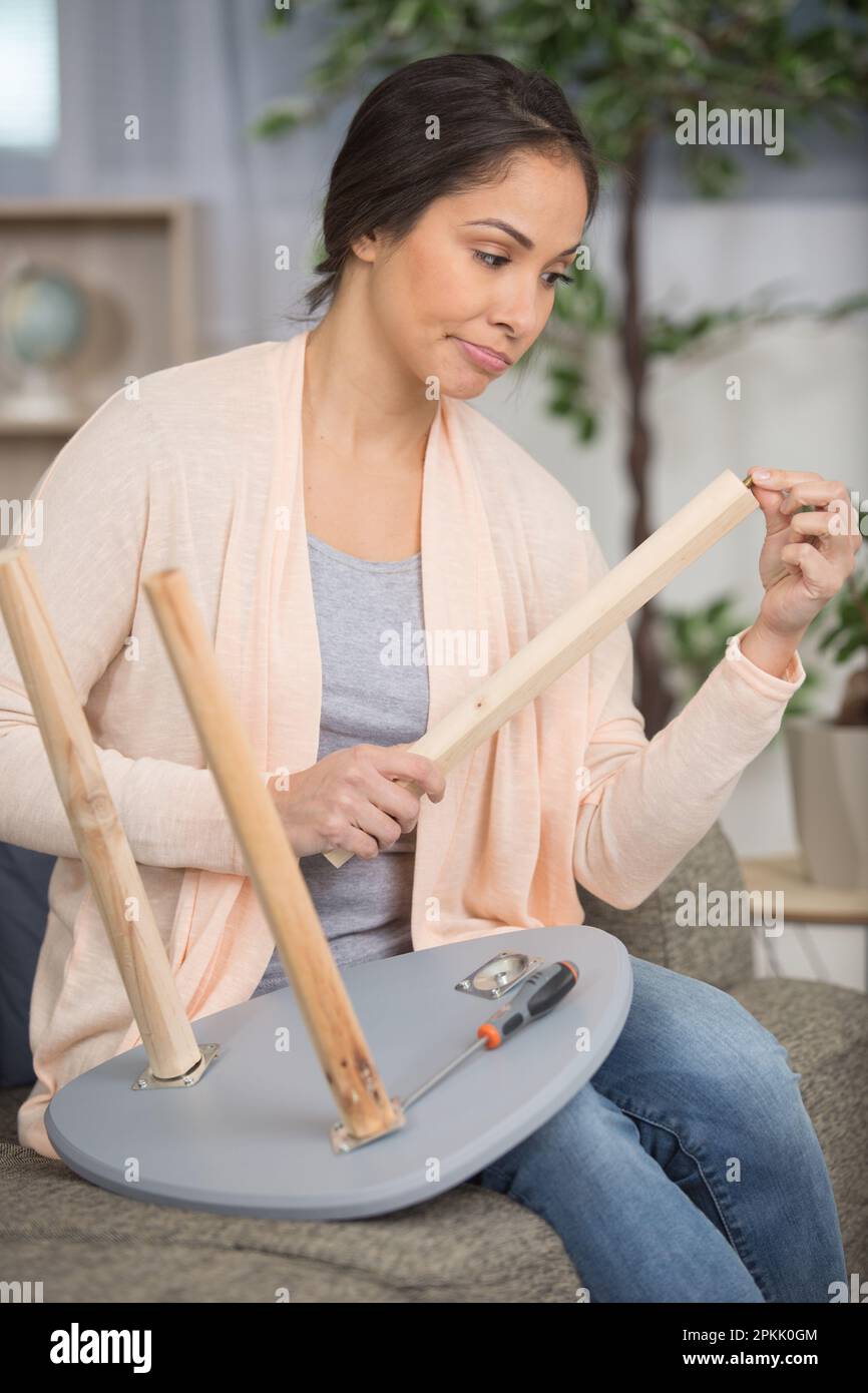 woman looking regretfully at broken stool Stock Photo - Alamy