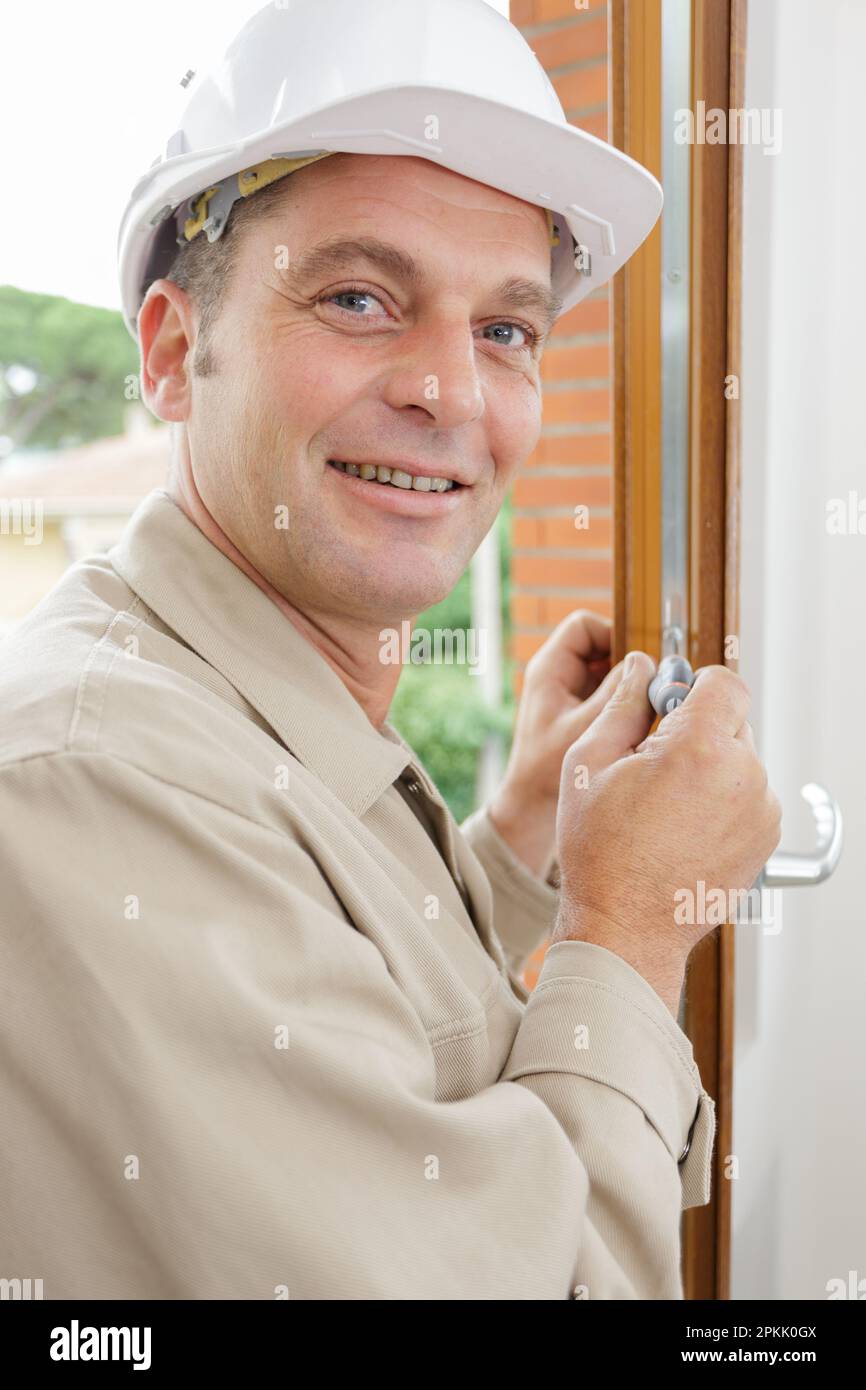 man during window installation process Stock Photo - Alamy