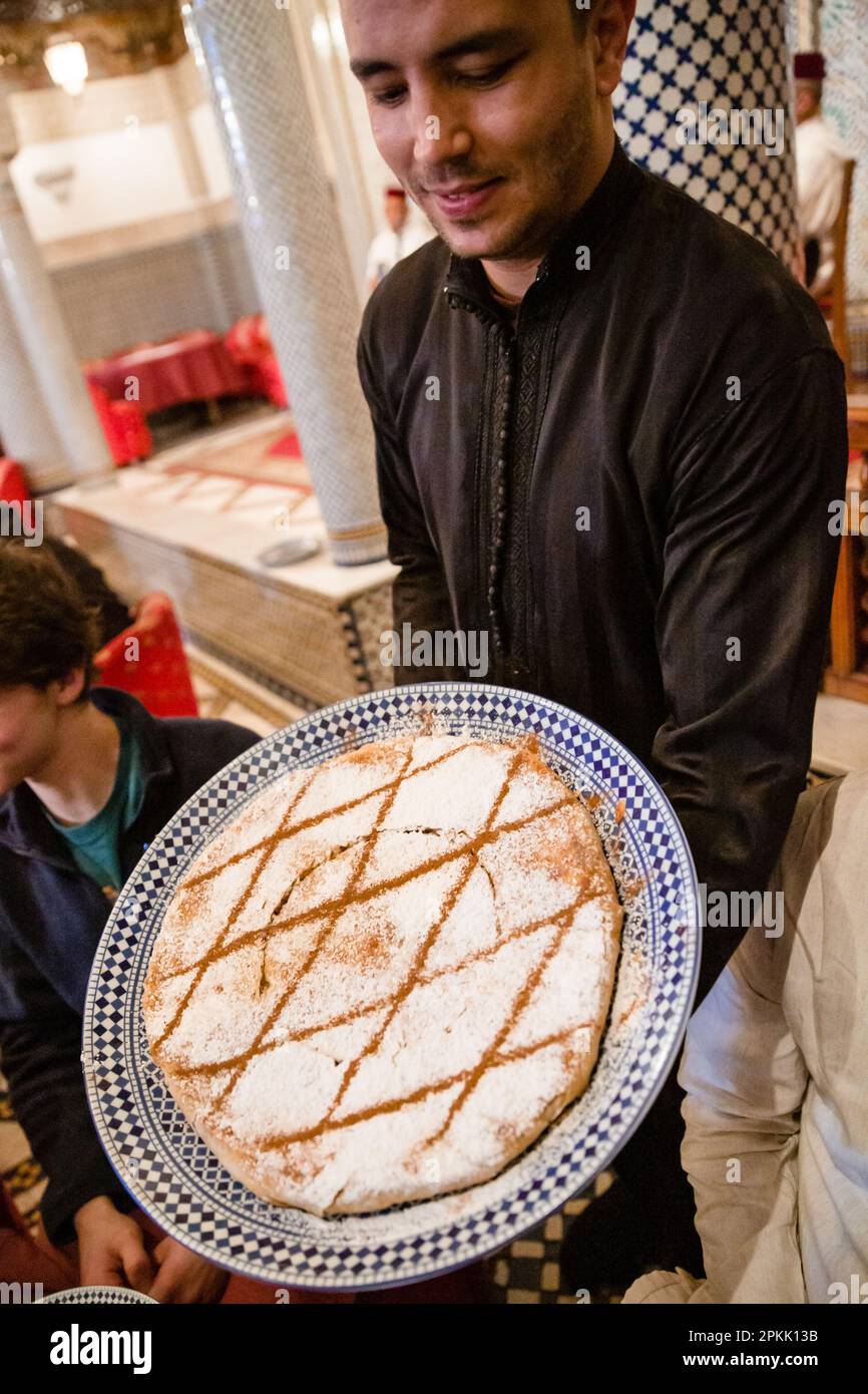 A waiter displays food on a platter at Palais la Medina in Fez Morocco ...