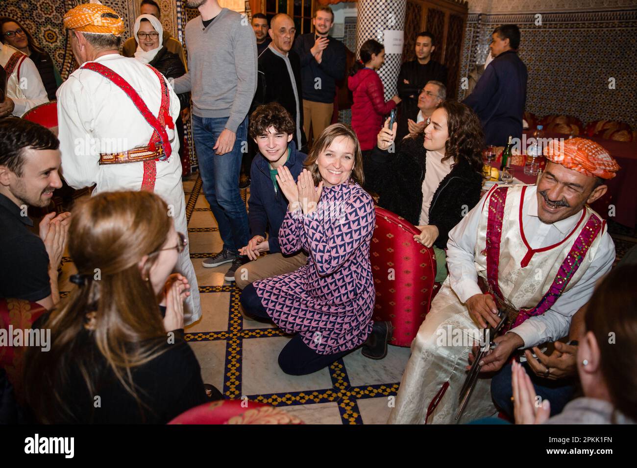 People clap and smile as performers move through the crowd at Palais la ...