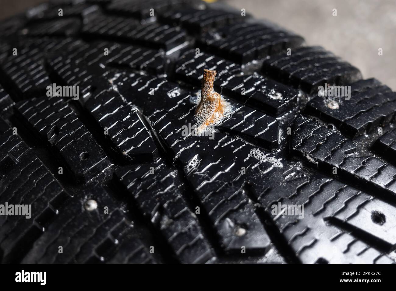 Nail sticks out of car's tire. Car wheel puncture. Close-up Stock Photo ...