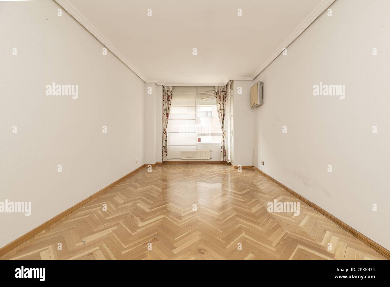 empty living room with plaster moldings on the ceiling, varnished ...