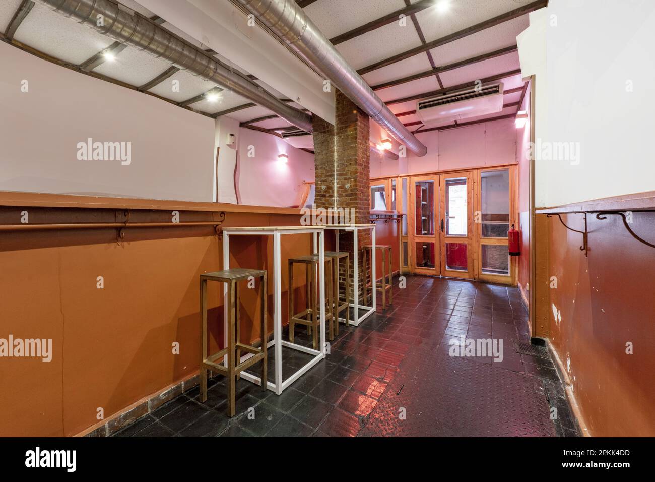 A cheaply built bar with high tables and matching stools Stock Photo ...