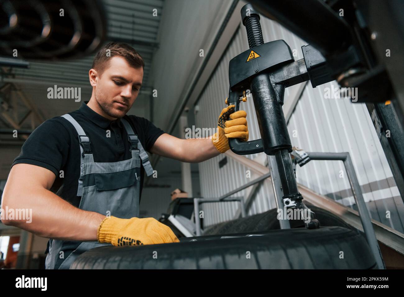 Strong hands. Man in uniform is working in the auto service Stock Photo ...