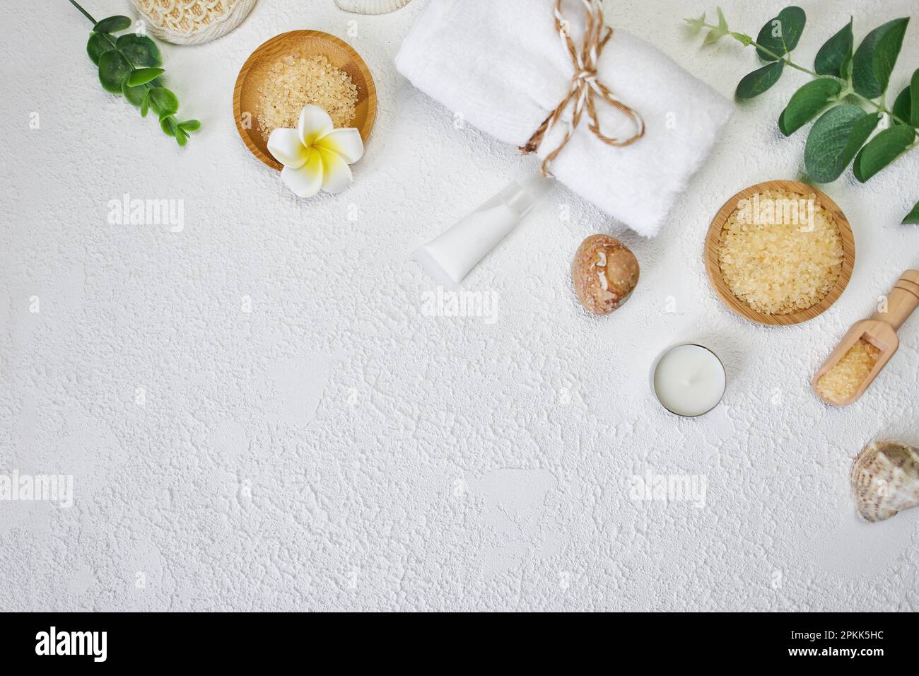 Spa treatment concept. Natural spa cosmetics products, sea salt, sea stone, massage brush, towel ...