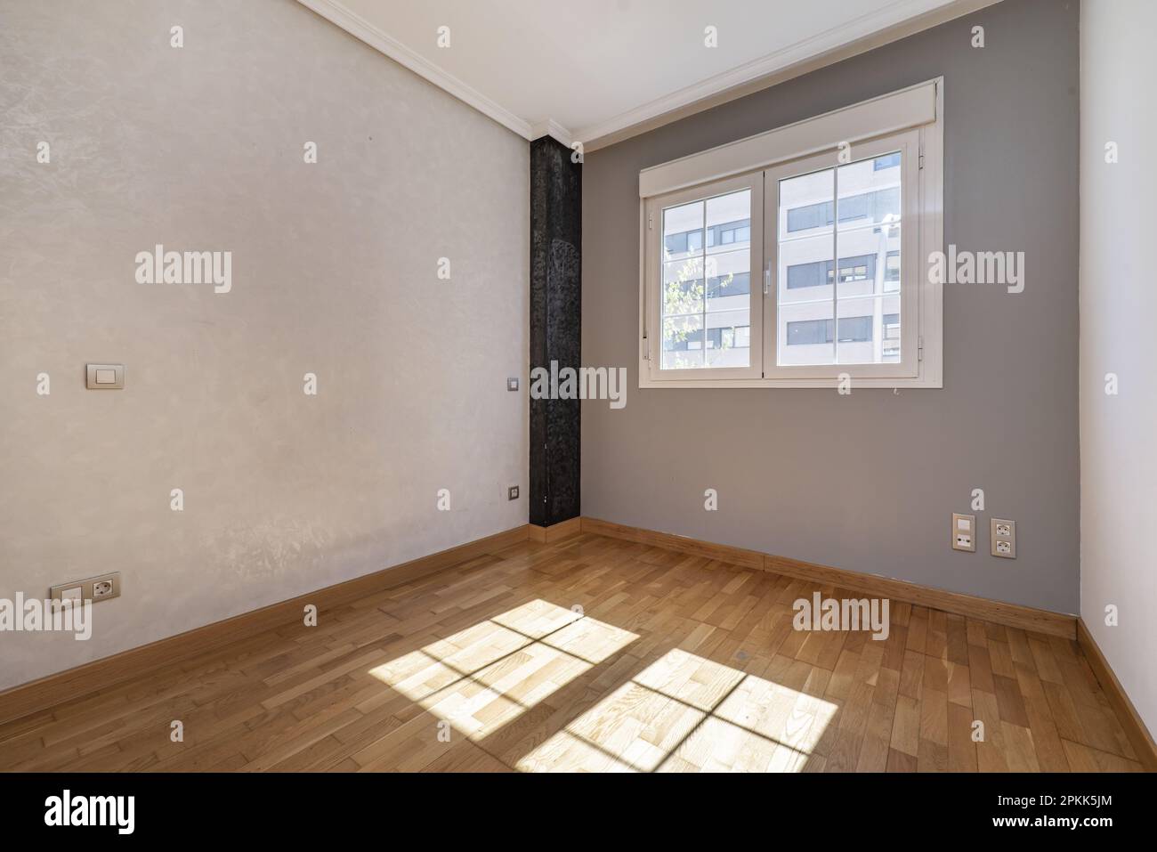 Empty room with French-style white aluminum windows with parquet floors ...