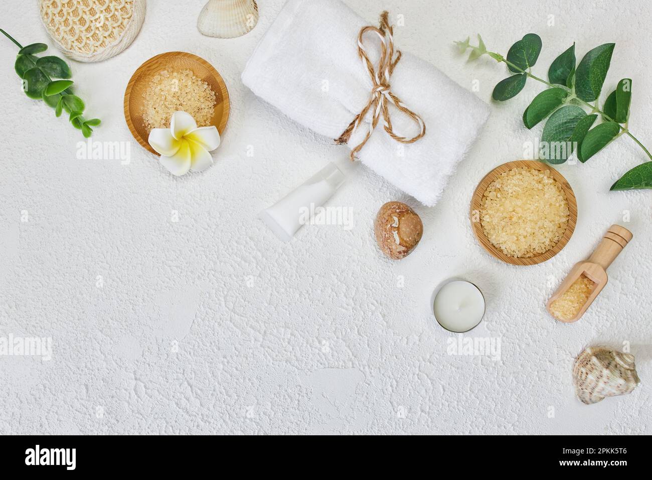 Spa treatment concept. Natural spa cosmetics products, sea salt, sea stone, massage brush, towel ...