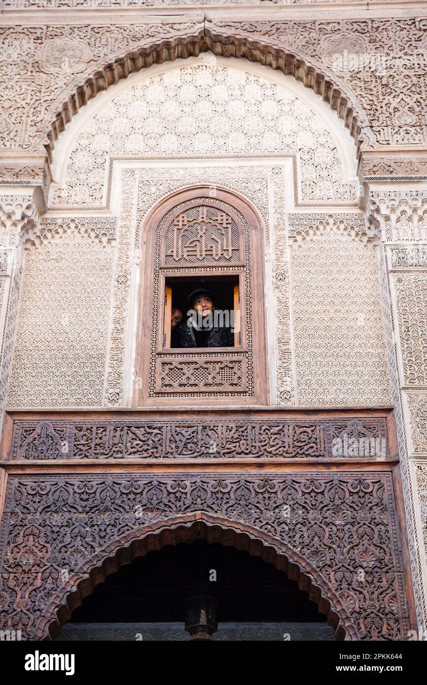 A person peeks out an arched window into the courtyard at Al-Atterine ...