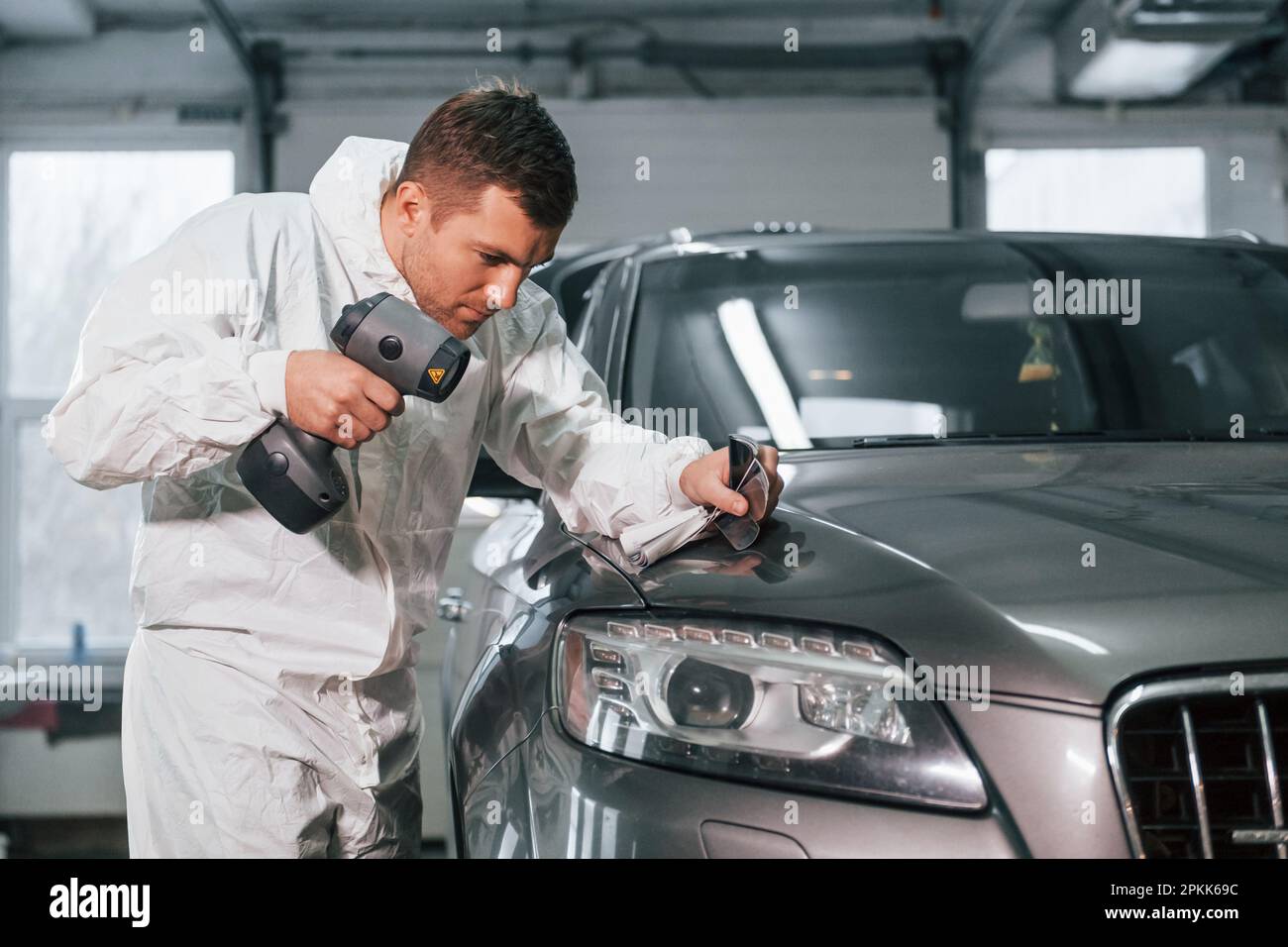 Professional worker. Man in uniform is in the auto service Stock Photo ...