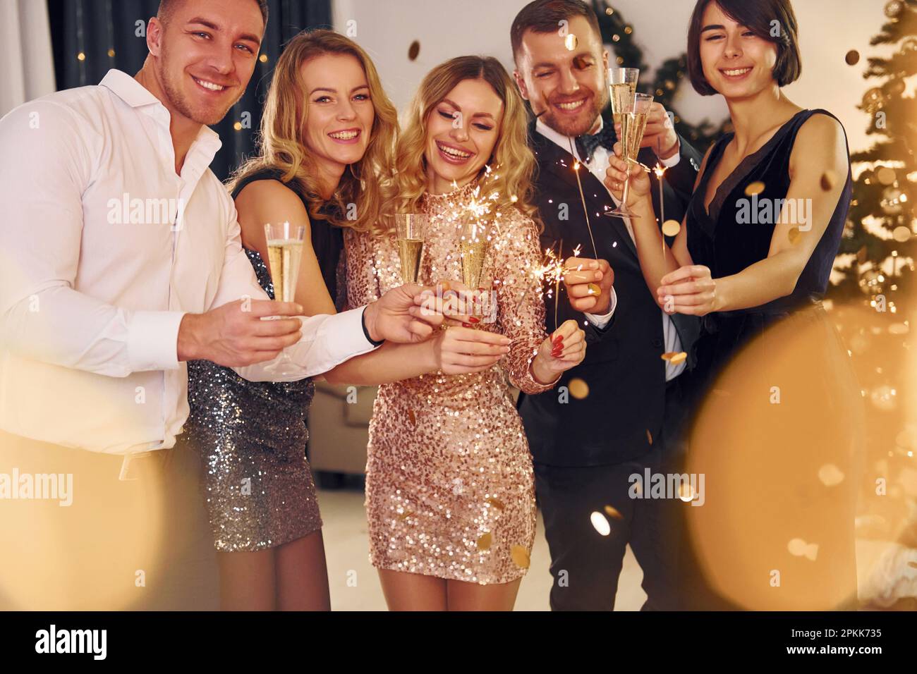 Celebration of new year. Group of people have a new year party indoors ...