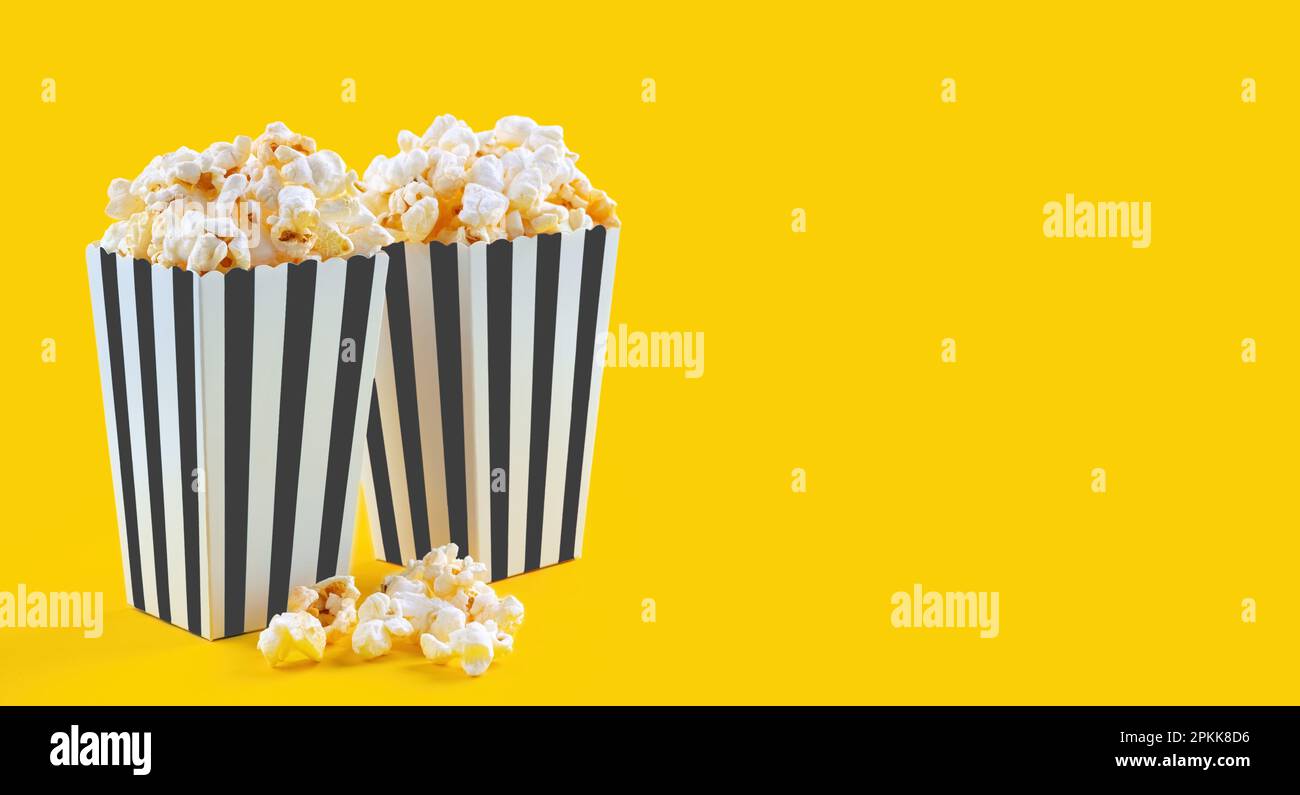 Two black white striped carton buckets with tasty cheese popcorn ...
