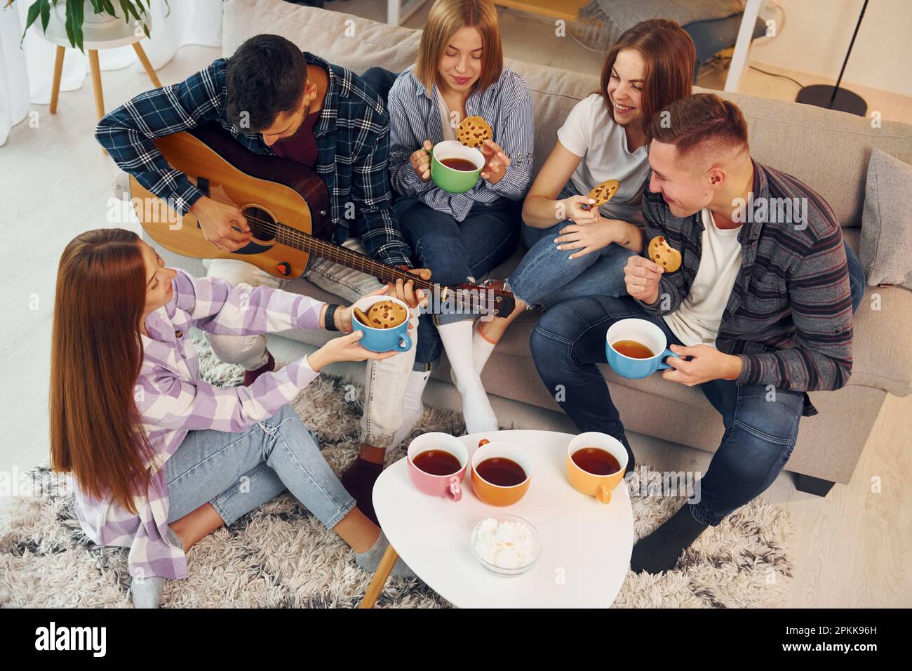 In domestic room. Group of friends have party indoors together Stock ...