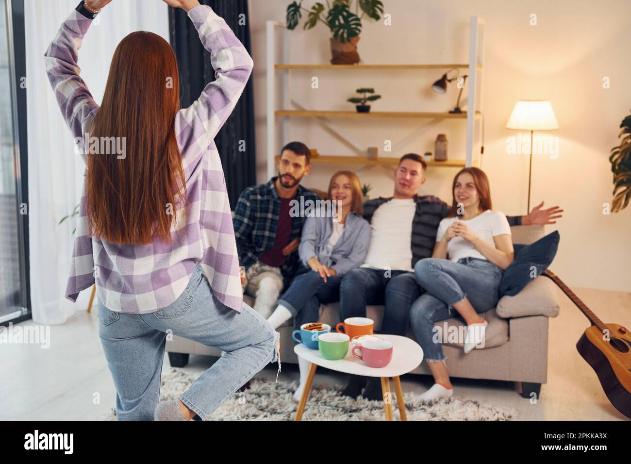 Playing game with using body language and poses. Group of friends have ...