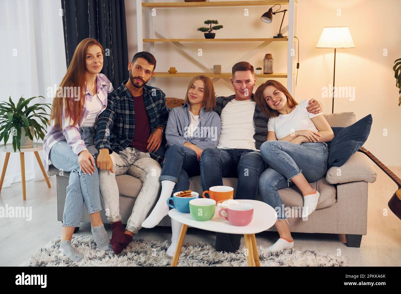 Free time entertainment. Group of friends have party indoors together ...