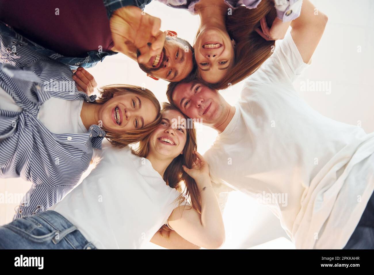 Looking down. Group of friends standing together Stock Photo - Alamy