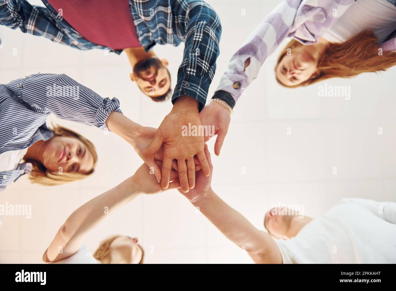 Holding each other's hands. Group of friends standing together Stock ...