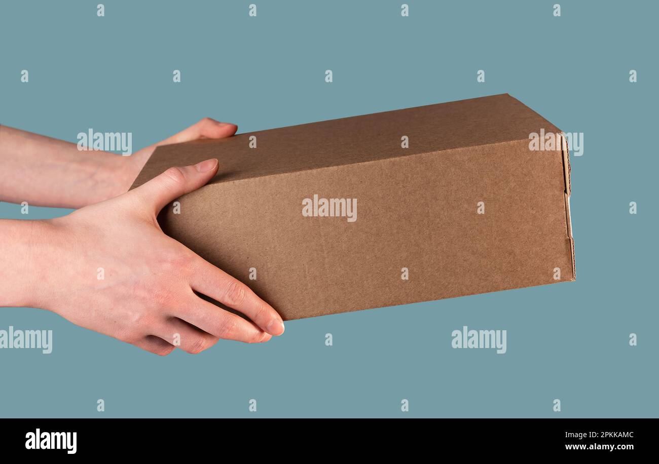 Hand holding, giving brown kraft cardboard box. Receiving carton ...