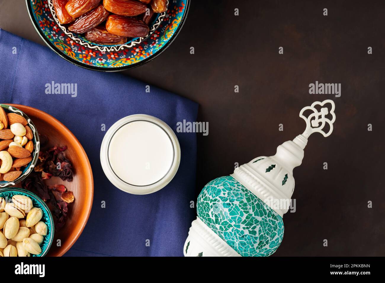 Dried dates, nuts and milk on a dark background. Ramadan Kareem and ...