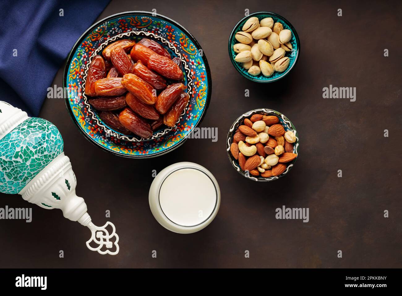 Dried dates, nuts and milk on a dark background. Ramadan Kareem and ...