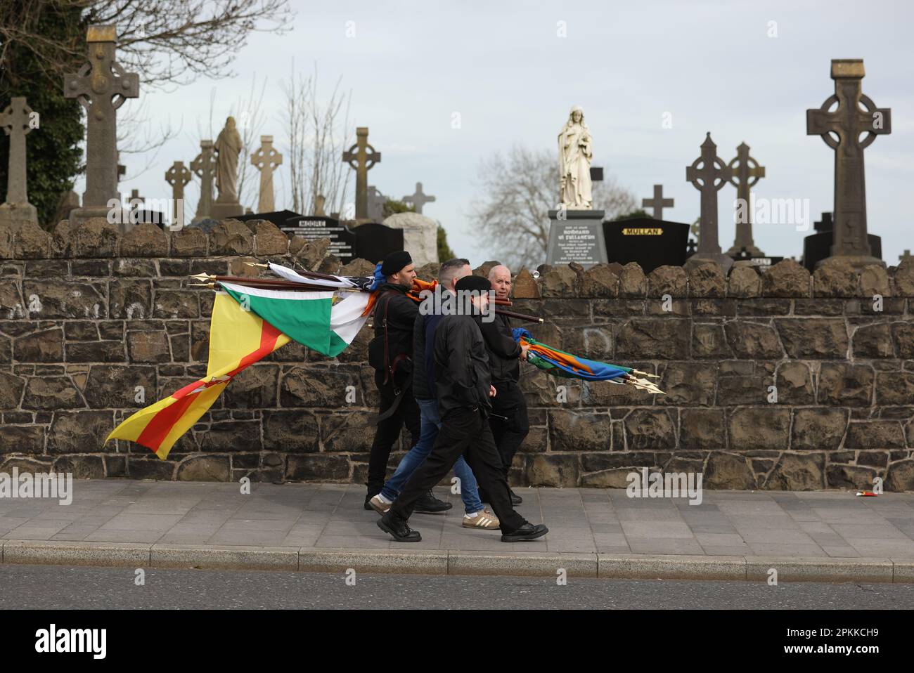 A colour party leaves Milltown Cemetery after an Easter commemoration ...
