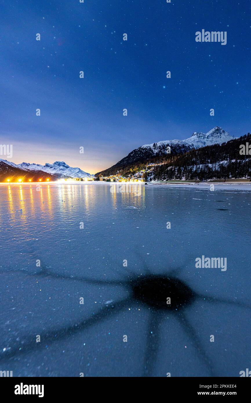 Cracked ice on the frozen surface of Lake Champfer in winter ...