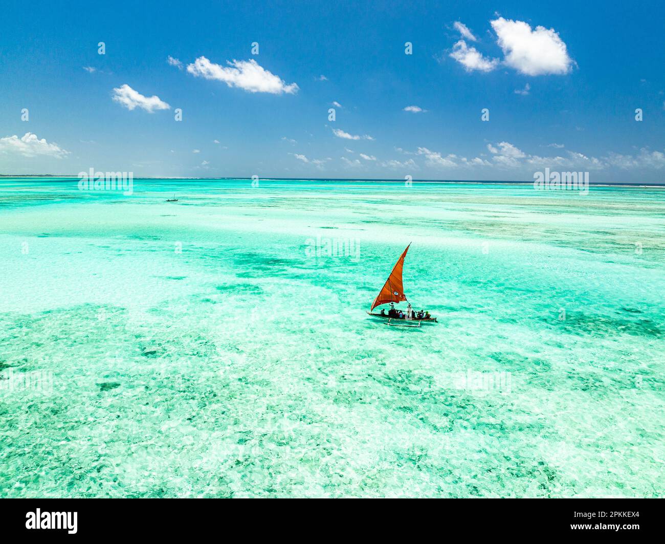 Tourists enjoying a boat trip on traditional dhow in the crystal sea ...