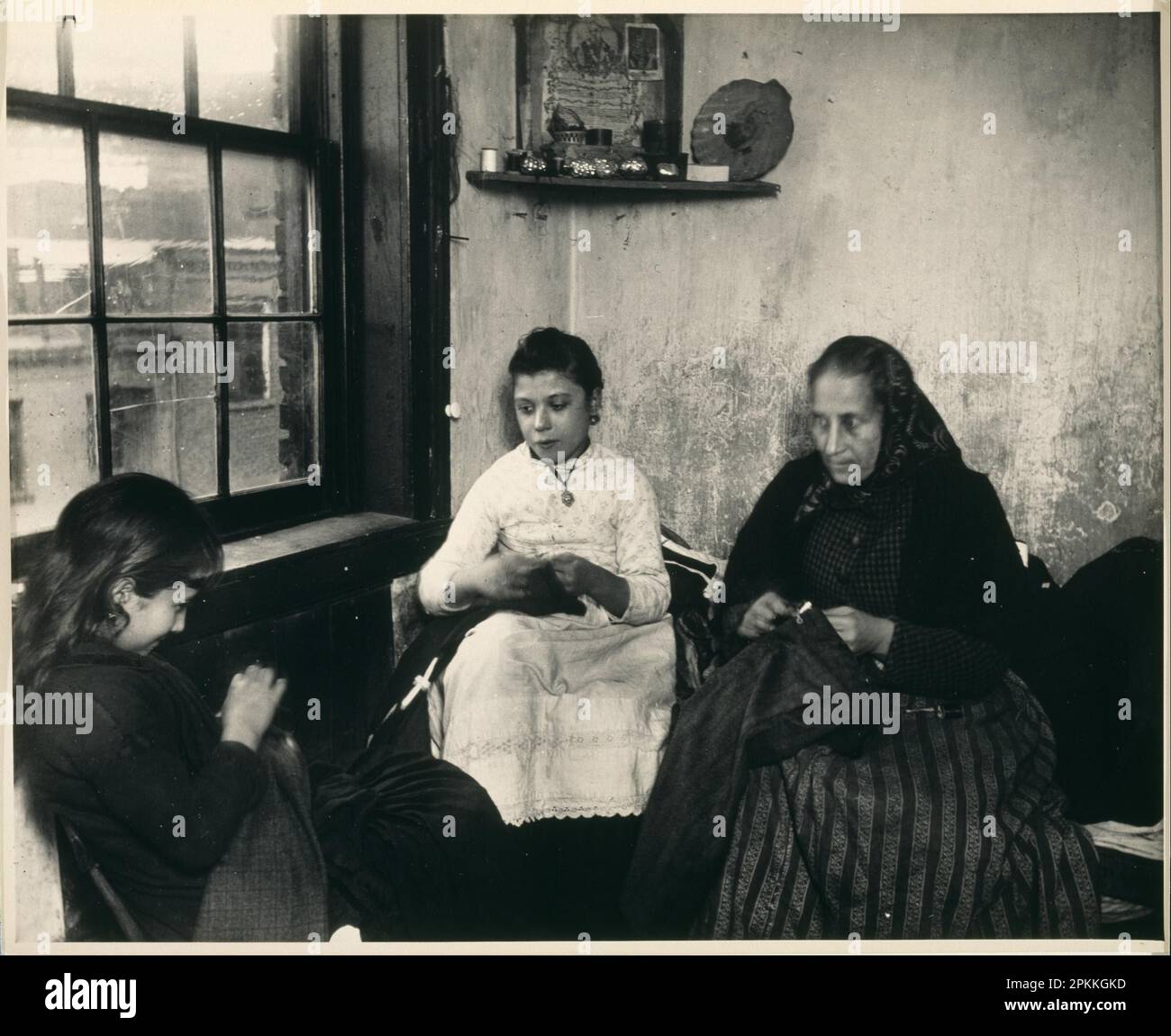 Sewing pants for the Sweater's in Gotham Court 1890/1900 by Jacob A. Riis Stock Photo - Alamy