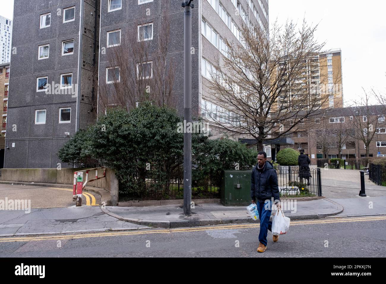 Man carrying his shopping in a plastic carrier bag outside Gambier ...