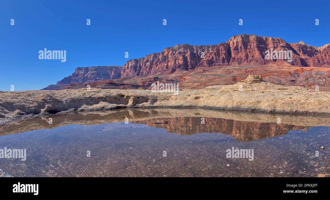 A pool of water reflecting the summit of Johnson Point below Vermilion ...