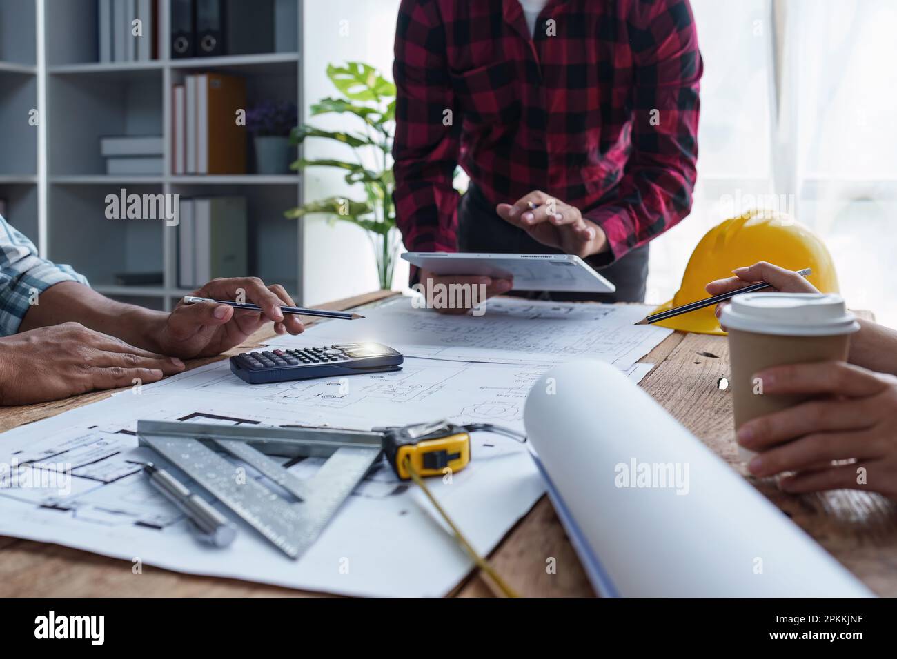 Architect and Engineer working with blueprints for architectural plan ...