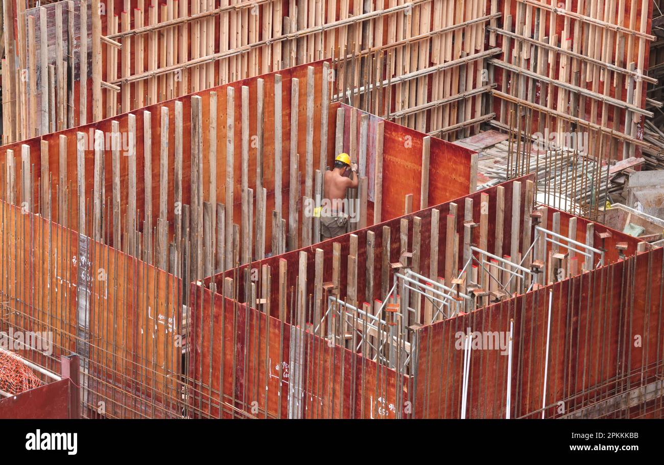 Site workers erect formwork at a construction site in Mongkok. 04APR23 ...
