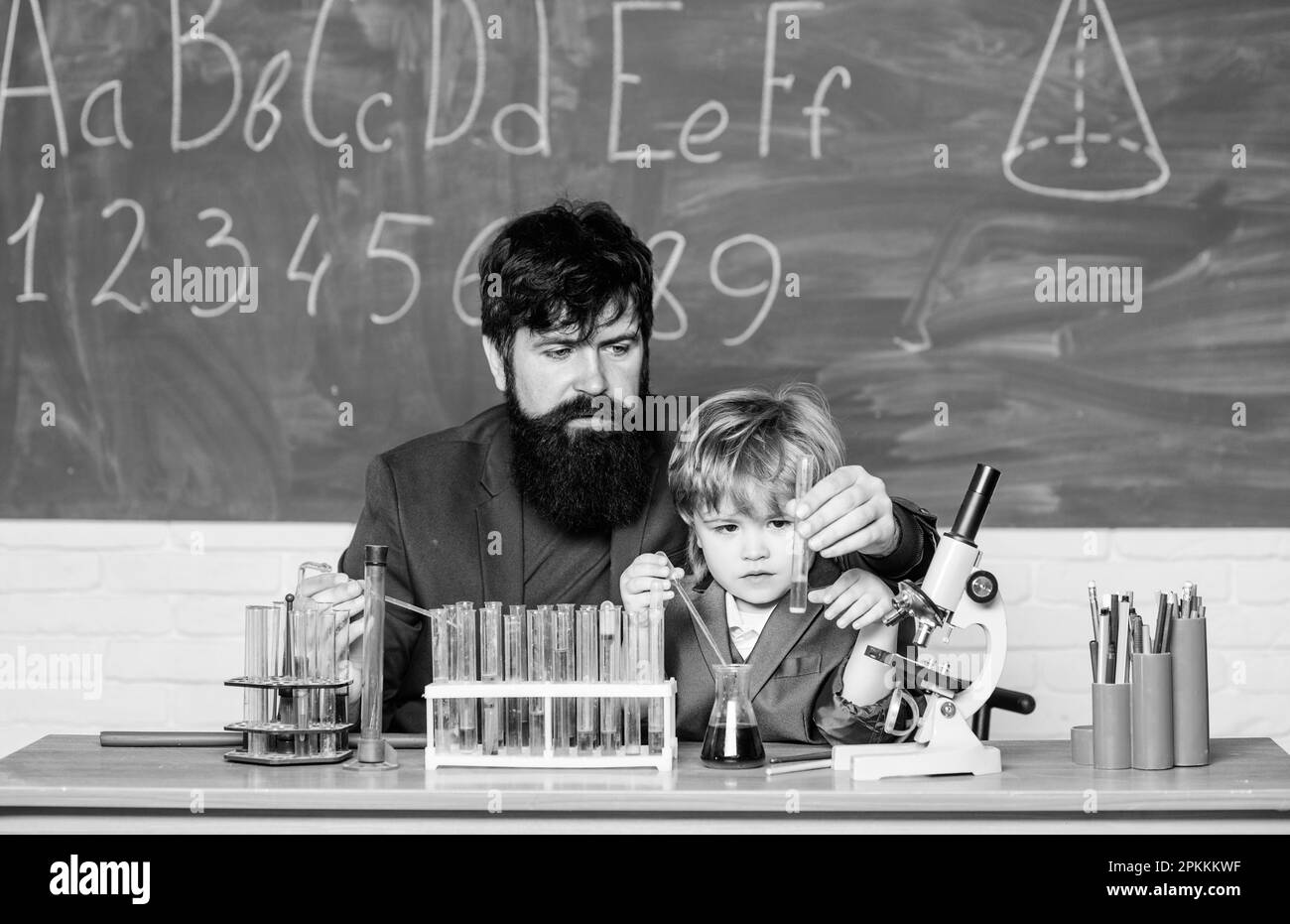 bearded man teacher with little boy. biotechnoloy research concept ...