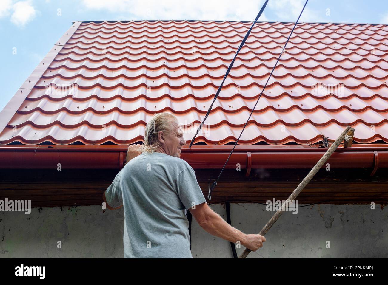 Cleaning a gutter on a rooftop hi-res stock photography and images - Alamy