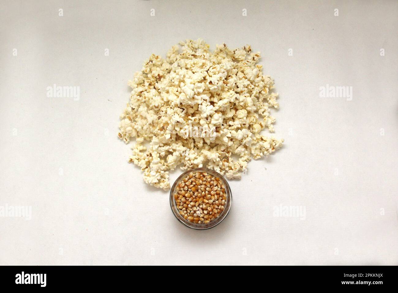 Natural popcorn with natural corn in a container or paper bag ready for ...