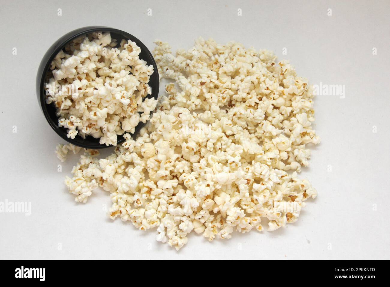 Natural popcorn with natural corn in a container or paper bag ready for ...