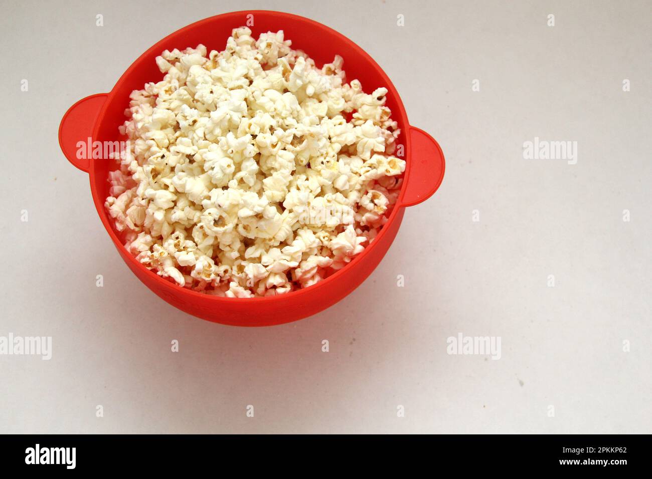 Natural popcorn with natural corn in a container or paper bag ready for ...