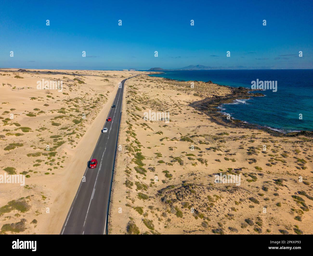 Aerial view of road through sand dunes overlooking the Atlantic Ocean ...