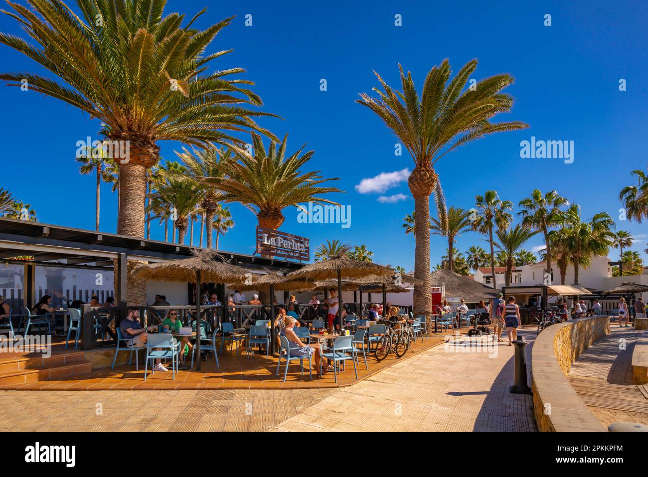 View of cafes and bars at Playa del Castillo Beach in Castillo Caleta ...