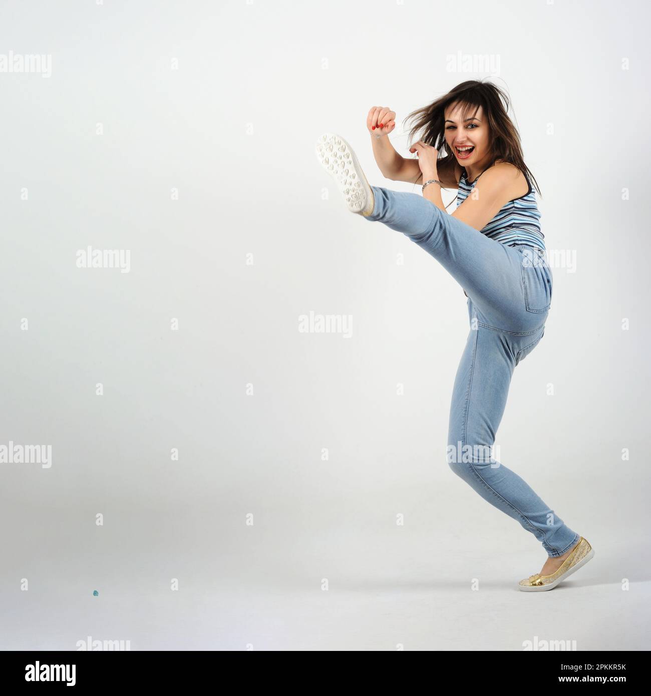 Young woman dancing hip-hop in the studio. White background, hands and ...
