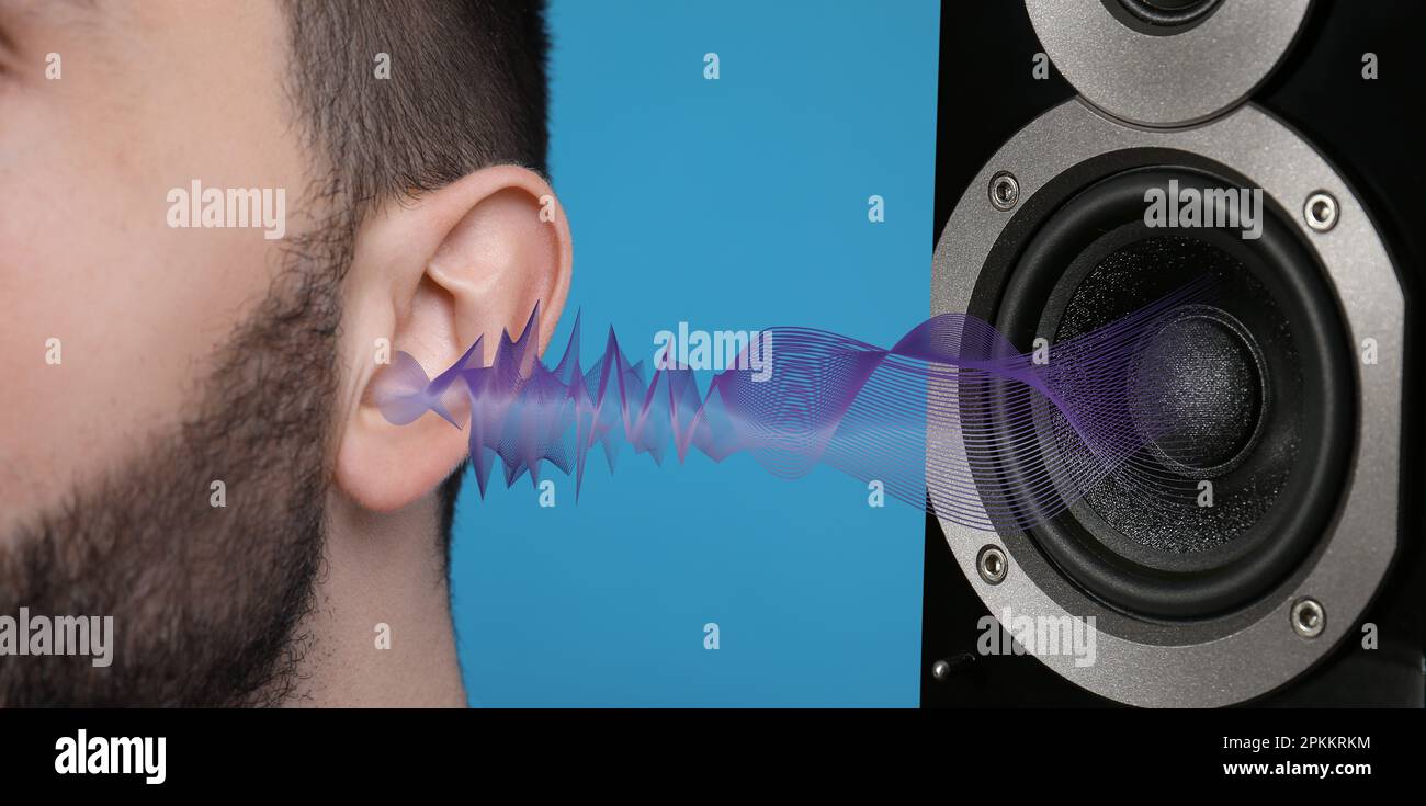 Modern audio speaker and man listening to music on light blue ...
