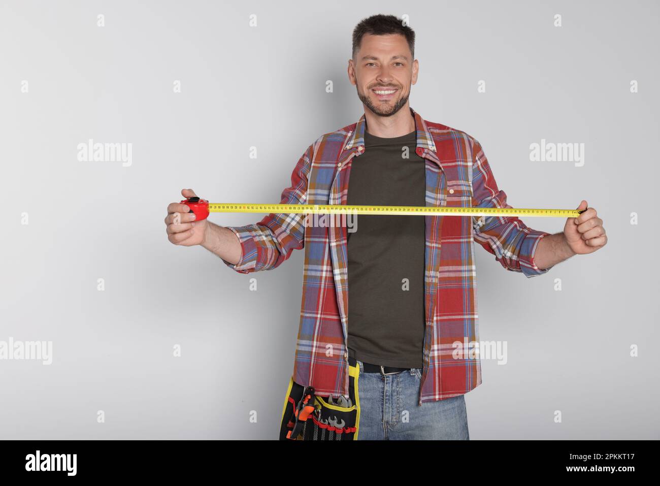 Handsome male worker measuring hi-res stock photography and images - Alamy
