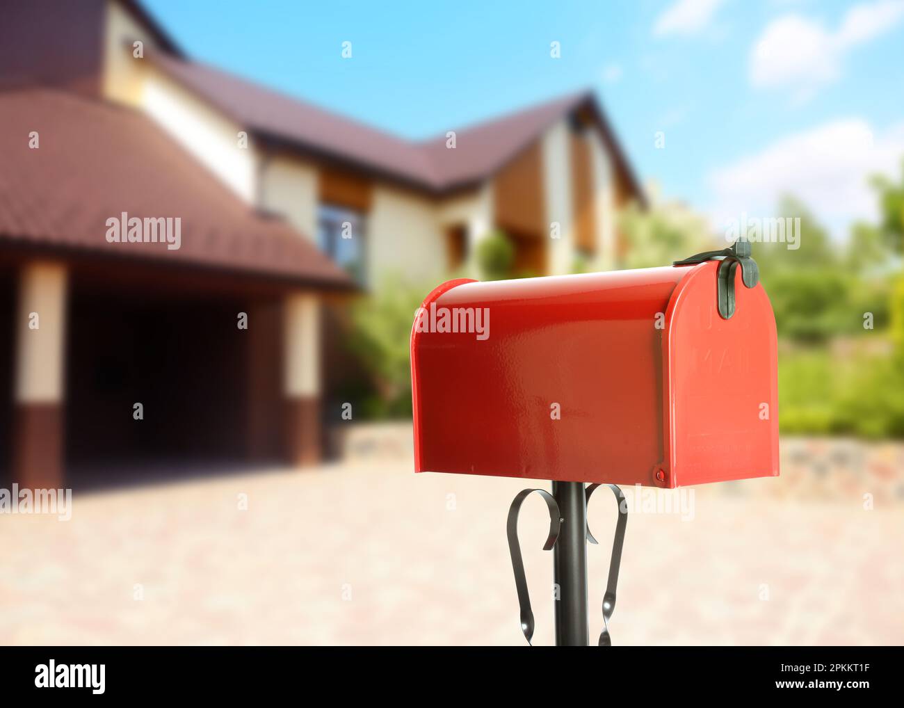 Red letter box and blurred view of modern house on sunny day Stock ...