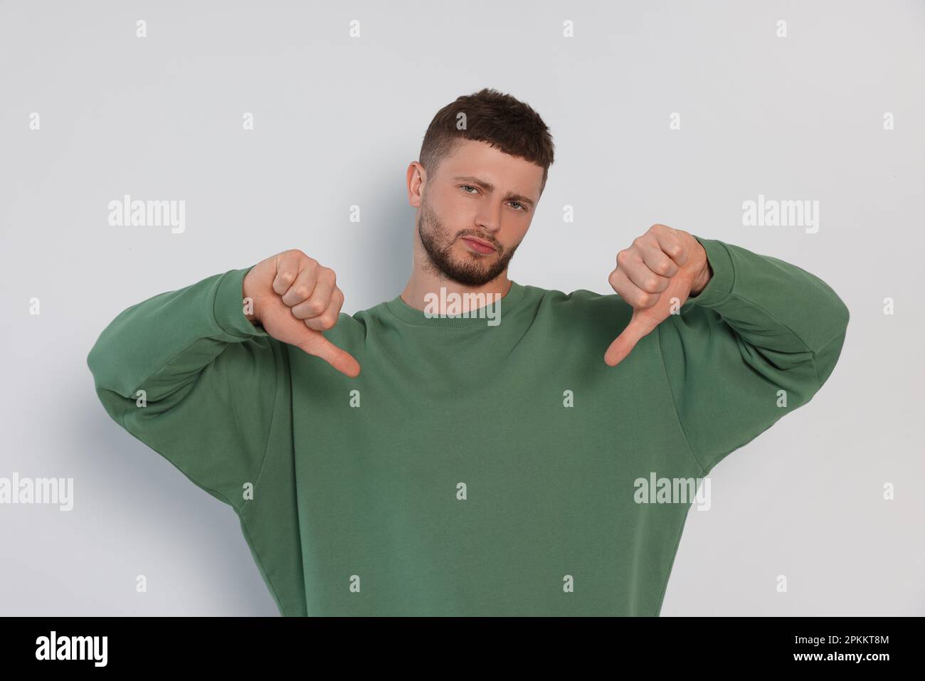 Portrait young man thumbs down hi-res stock photography and images - Alamy